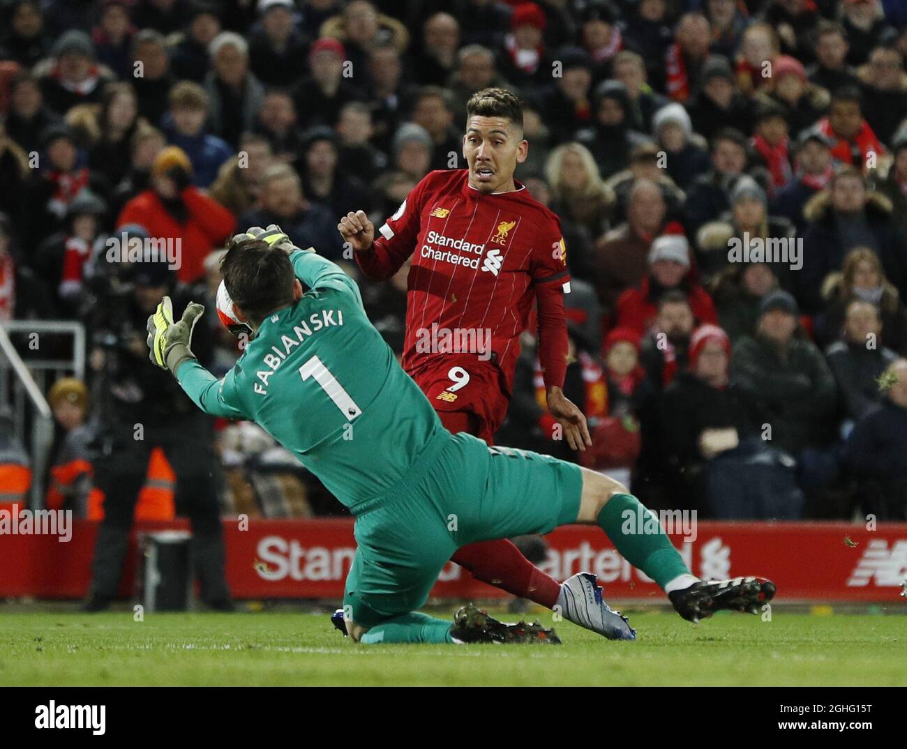 Lukasz Fabianski of West Ham United saves from Roberto Firmino of ...