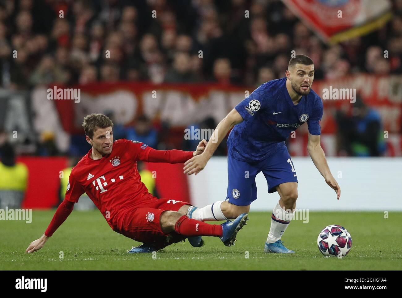 Thomas Muller of Bayern Munich tackles Mateo Kovacic of Chelsea during ...