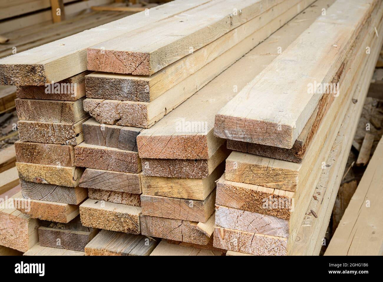Piles of wooden planks at the sawmill for the manufacture of cladding ...