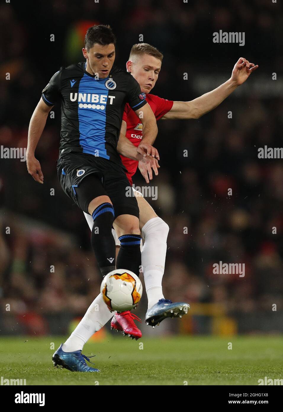 Federico Ricca of Clube Brugge holds off Scott McTominay of Manchester ...