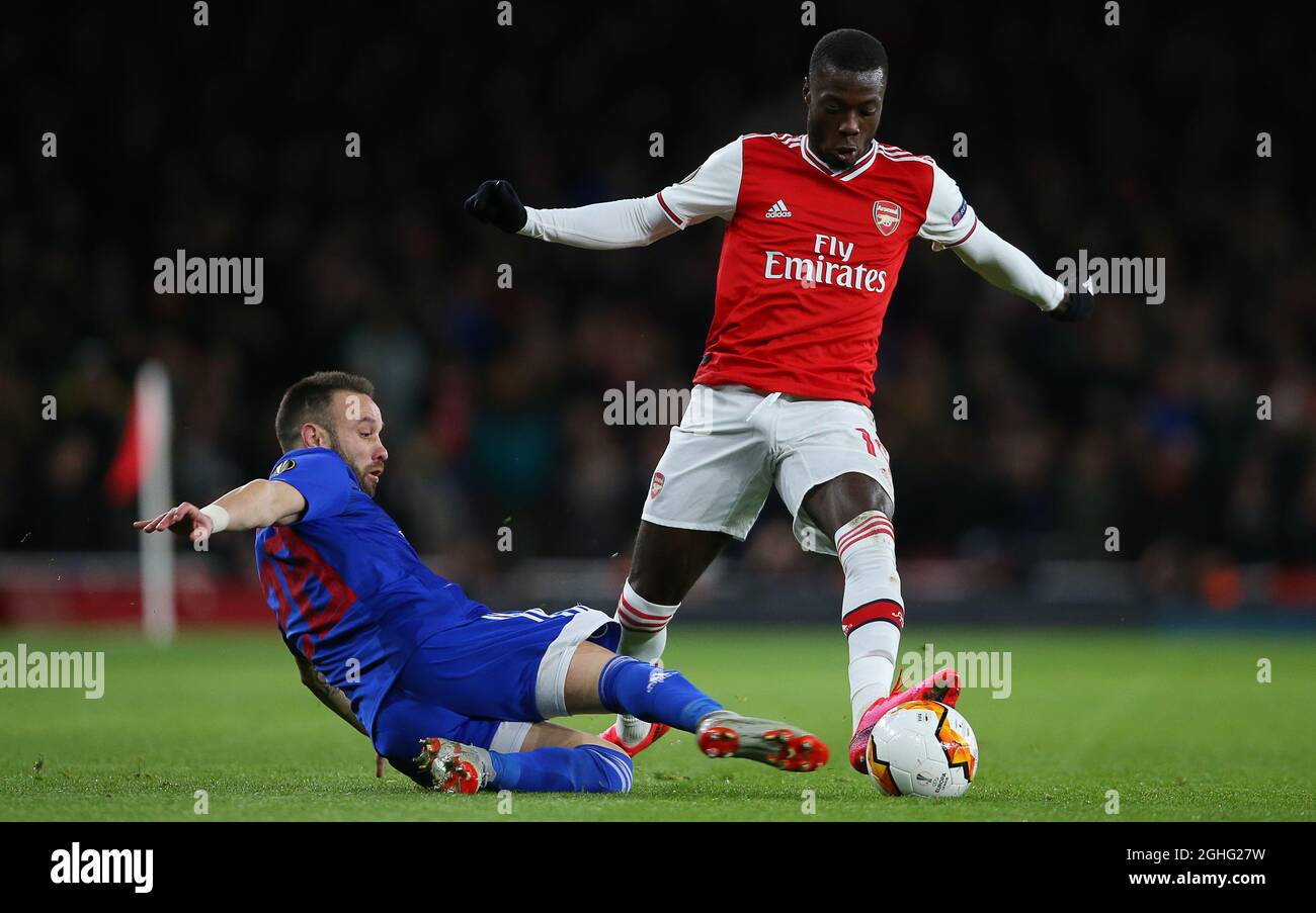 Arsenal's Nicolas Pepe is challenged by OlympiakosÕ Mathieu Valbuena ...