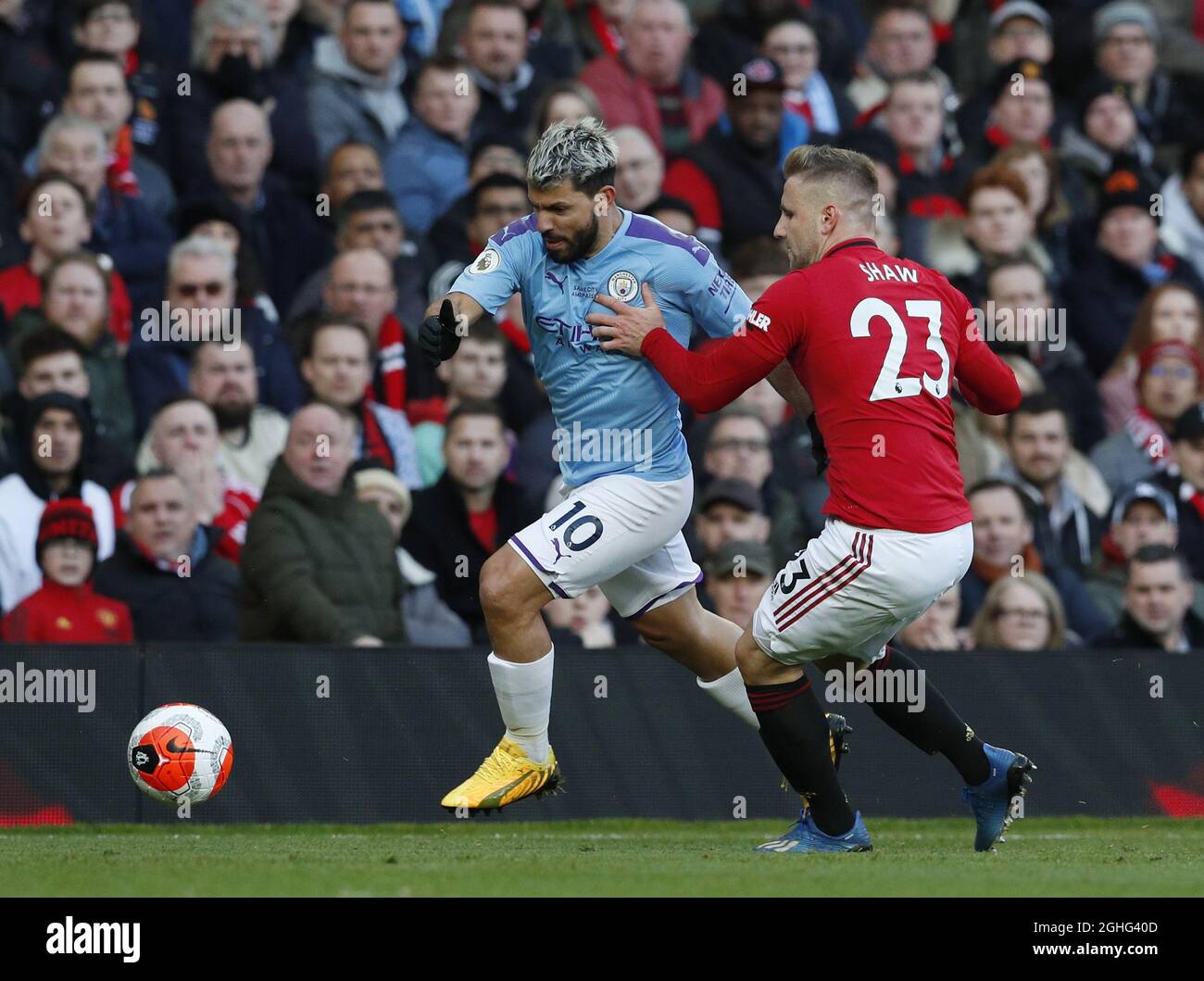 Sergio Aguero of Manchester City runs past Luke Shaw of Manchester ...