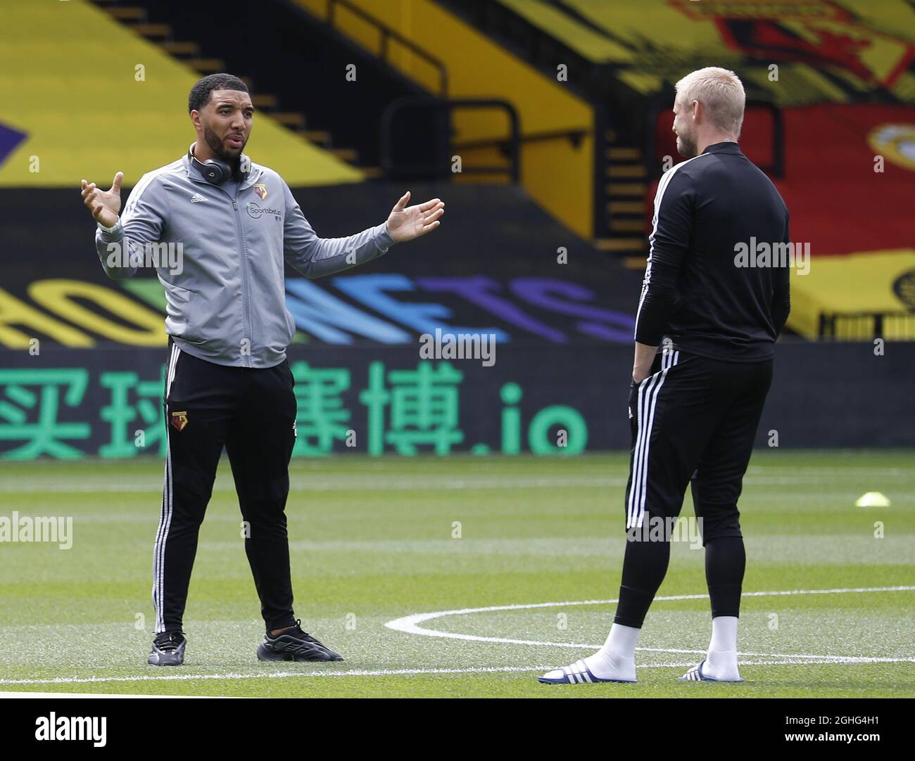 Troy Deeney of Watford talks to Kasper Schmeichel of Leicester City ...