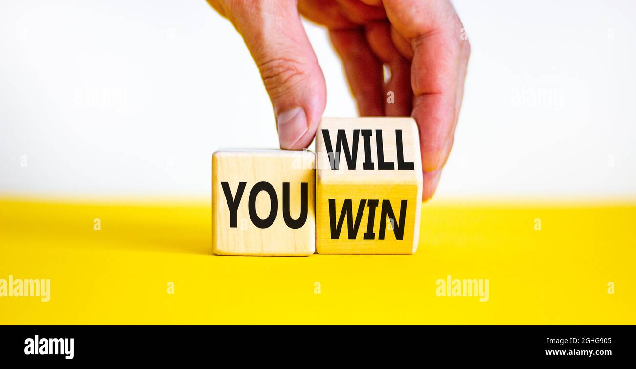 You will win symbol. Businessman turns a cube and changes words you ...