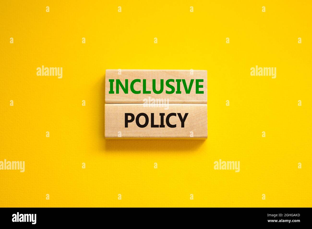 Inclusive policy symbol. Wooden blocks with words Inclusive policy on ...