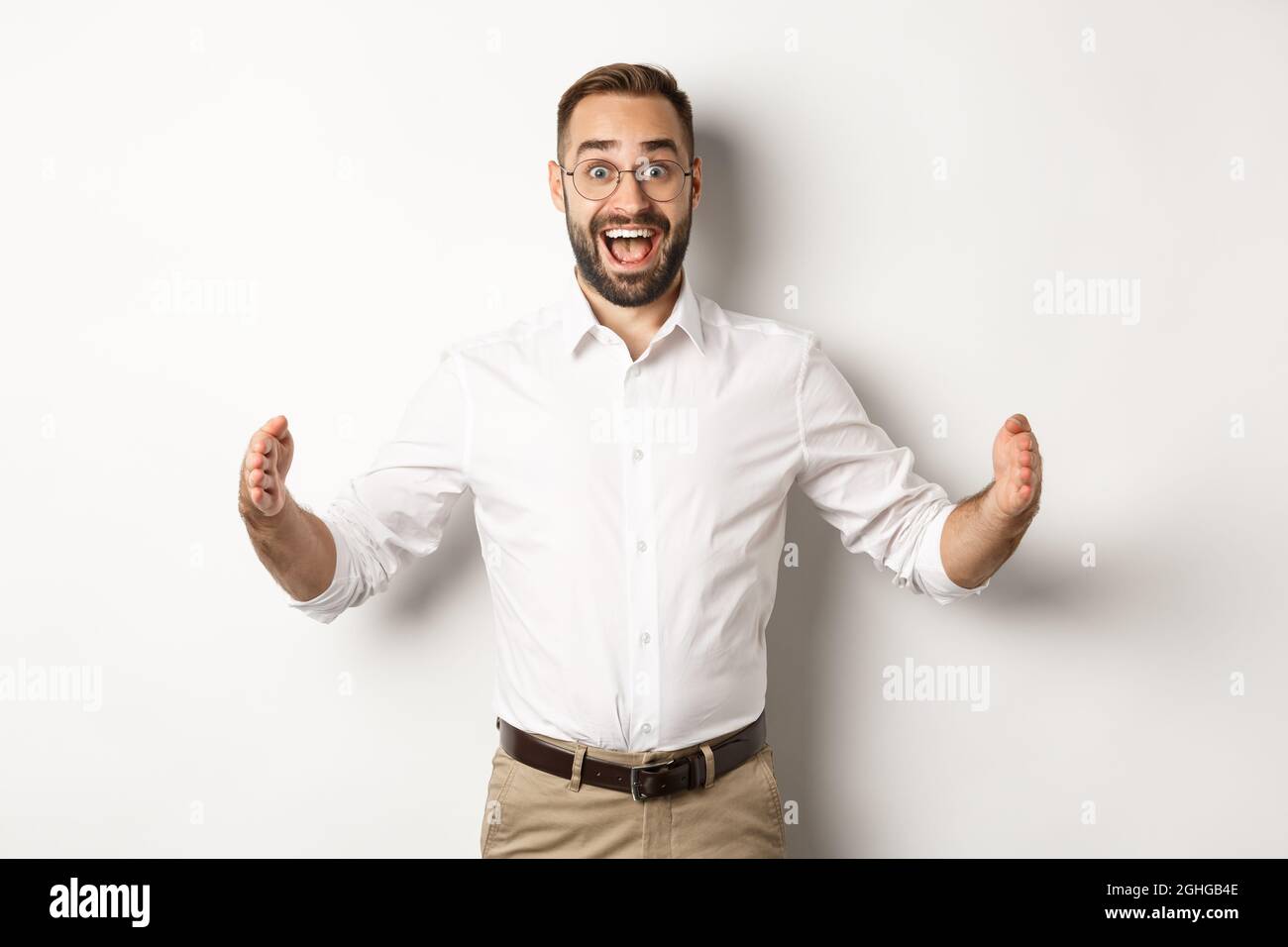 Amazed businessman showing big object, describe something large and ...