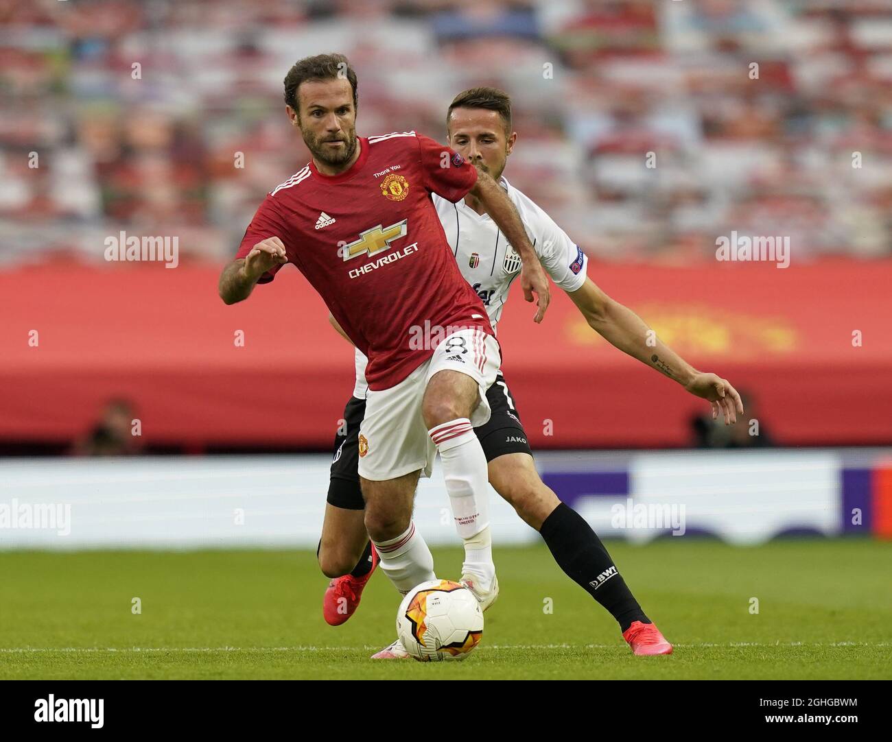 Rene Renner of Lask Linz tackles Juan Mata of Manchester United during ...