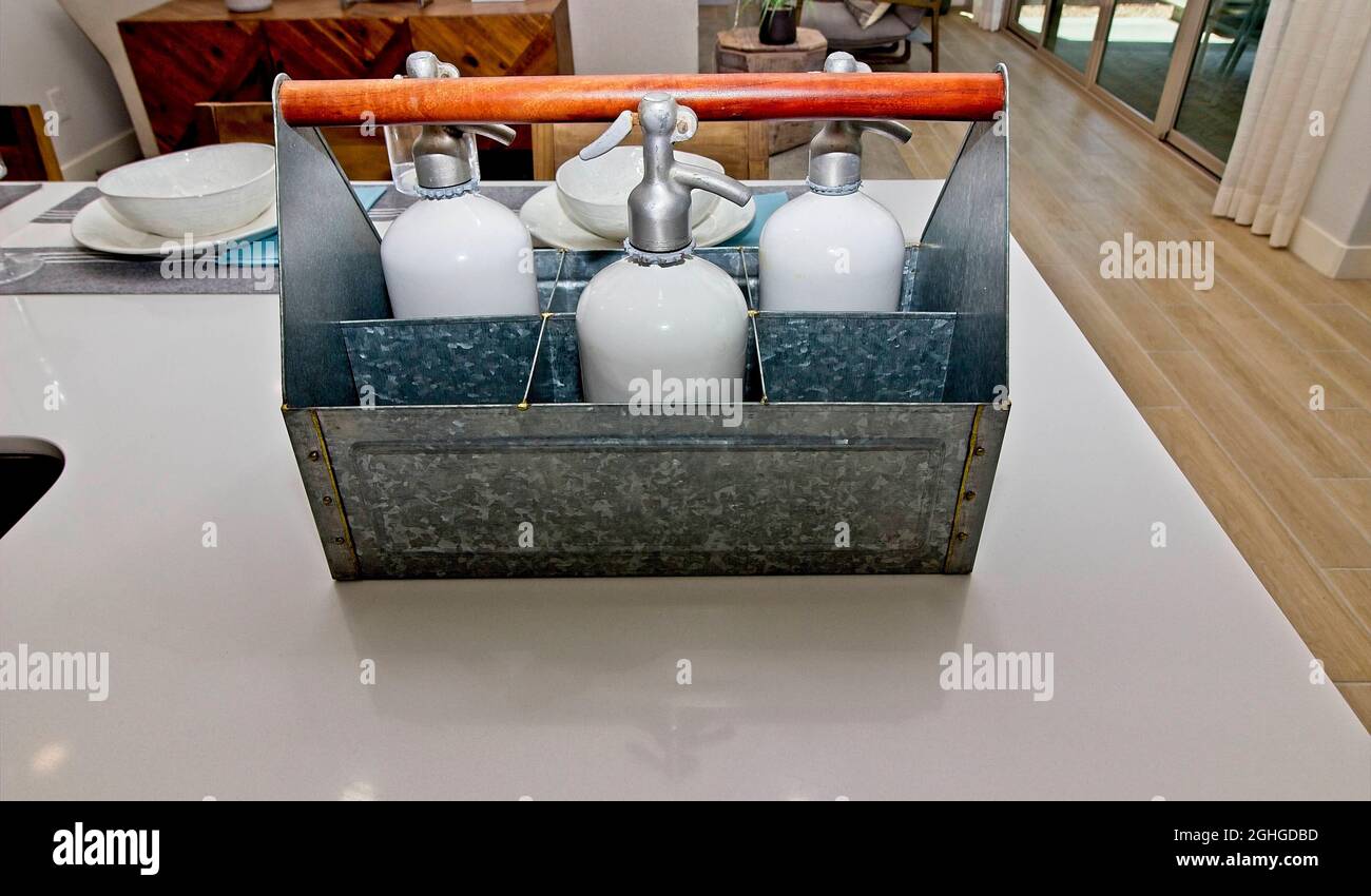 Metal Container Of Three Seltzer Bottles Stock Photo - Alamy