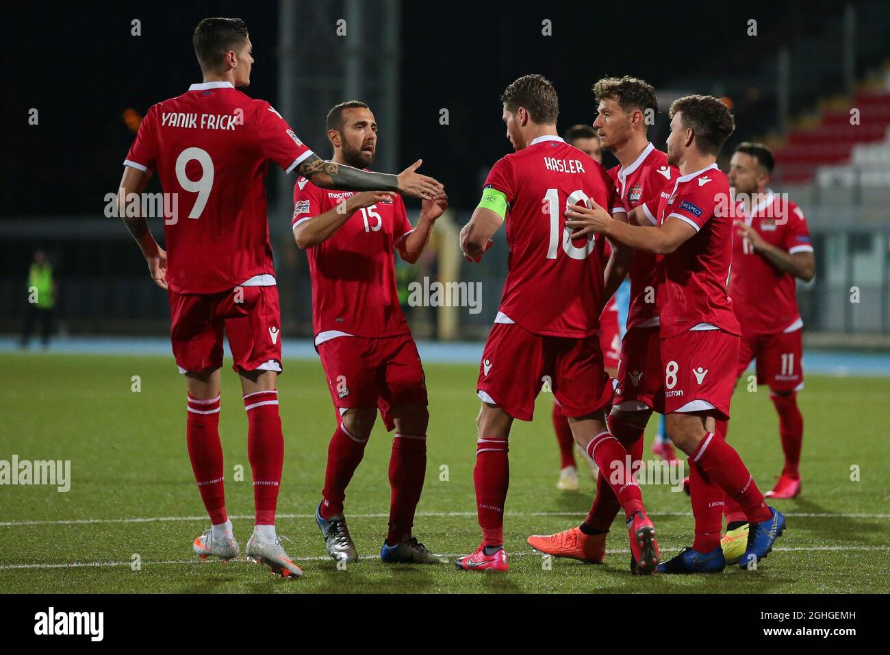 Nicolas Hasler of Liechtenstein celebrates with team mate Aron Sele ...