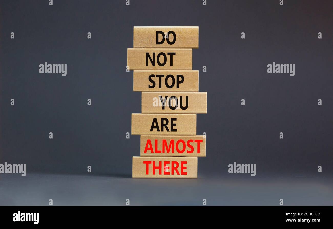 You are almost there symbol. Wooden blocks with words 'do not stop you ...