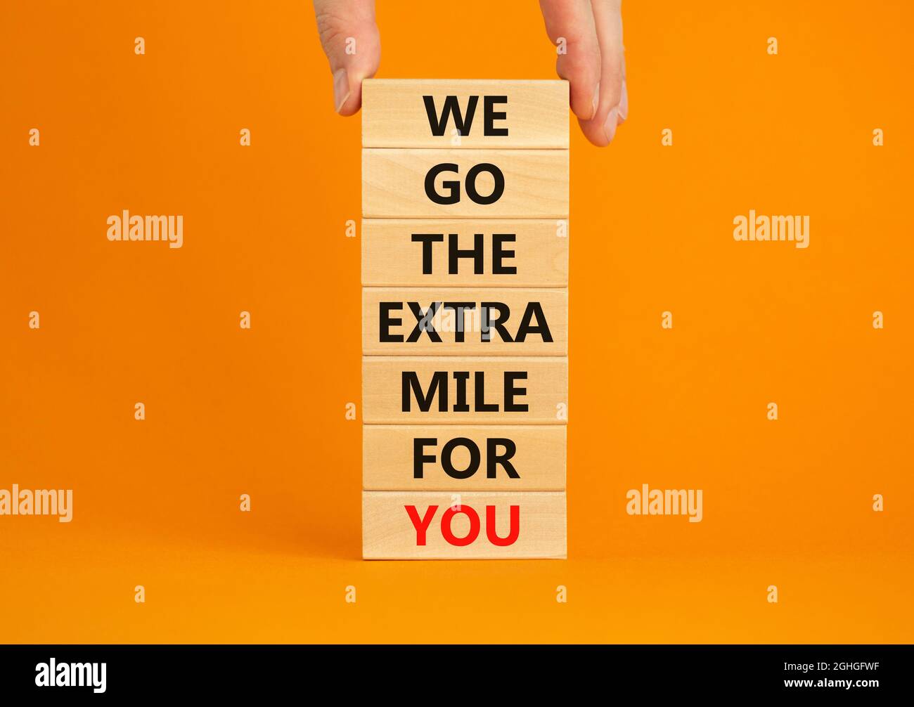 Go the extra mile symbol. Wooden blocks with words 'We go the extra ...