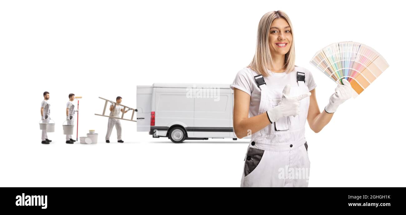 Female painter holding a color palette and workers with a white van ...