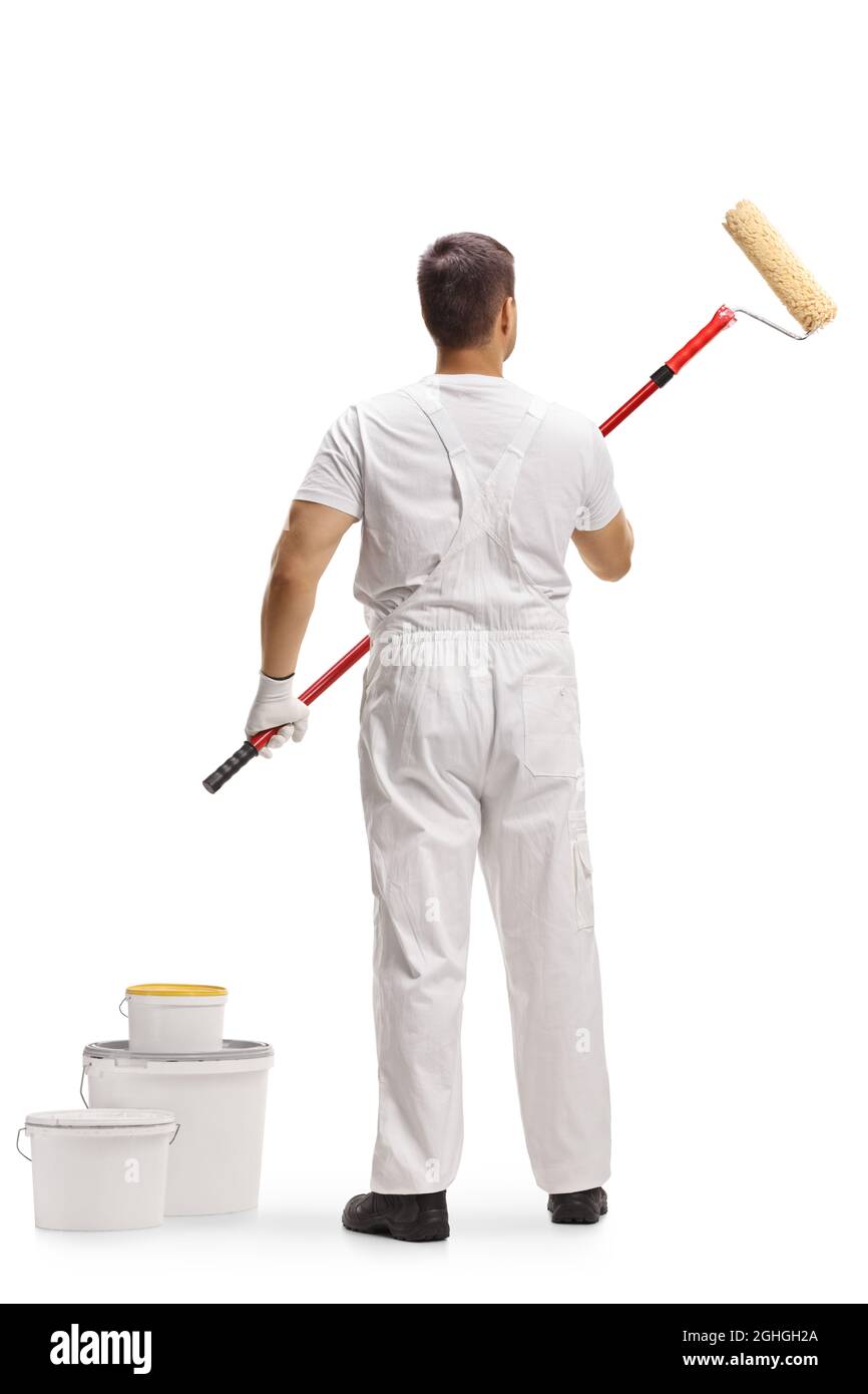 Rear view of a house painter using a paint roller and painting isolated ...