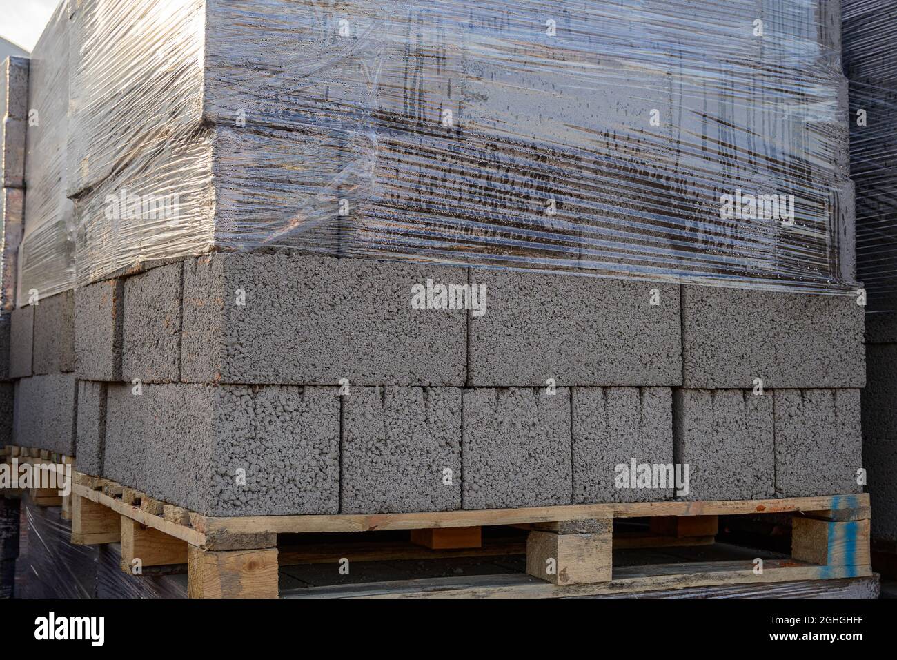 Foam concrete blocks covered with packaging film on wooden pallets in ...