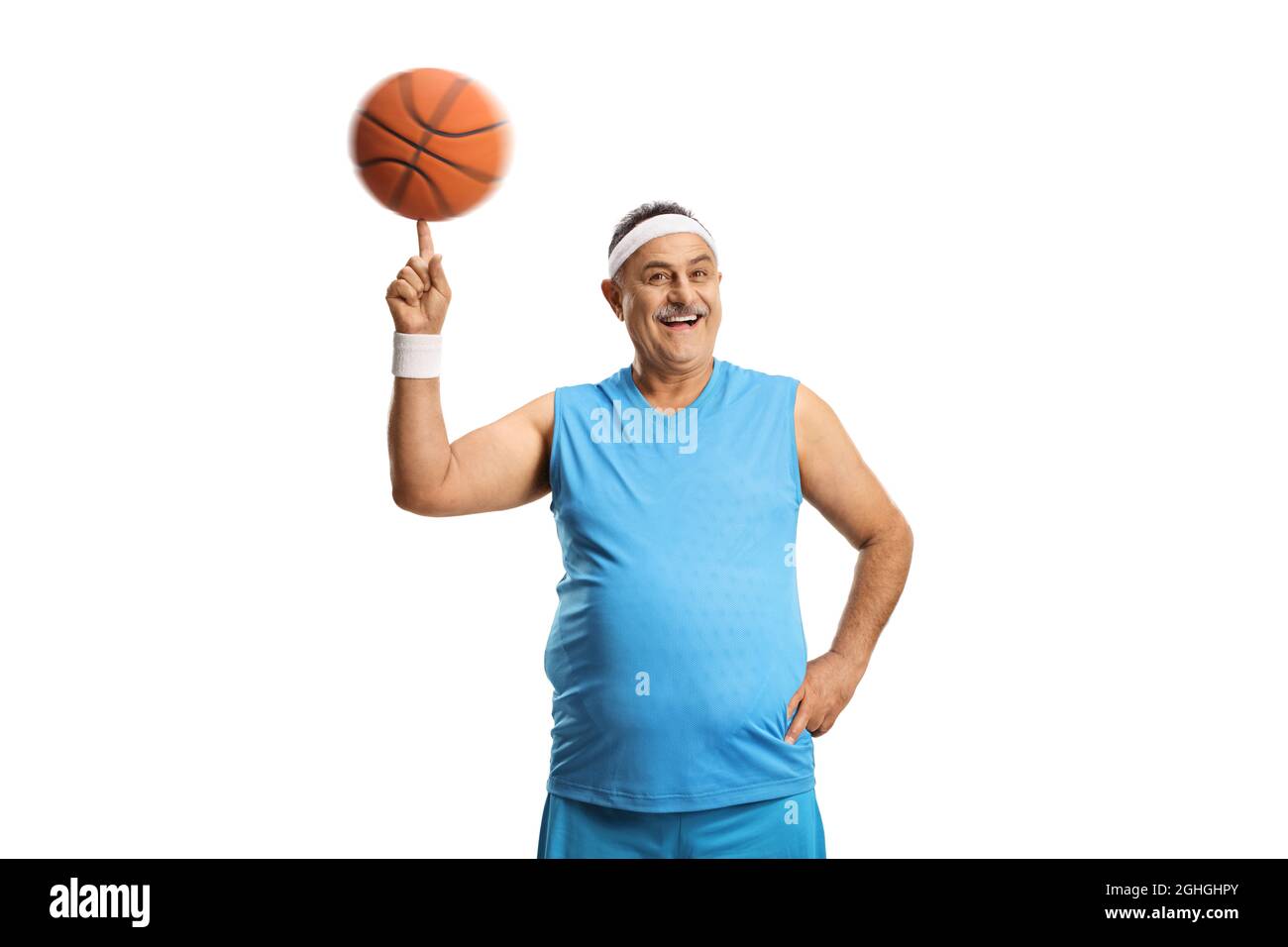 Cheerful mature man spinning a basketball with his finger isolated on ...