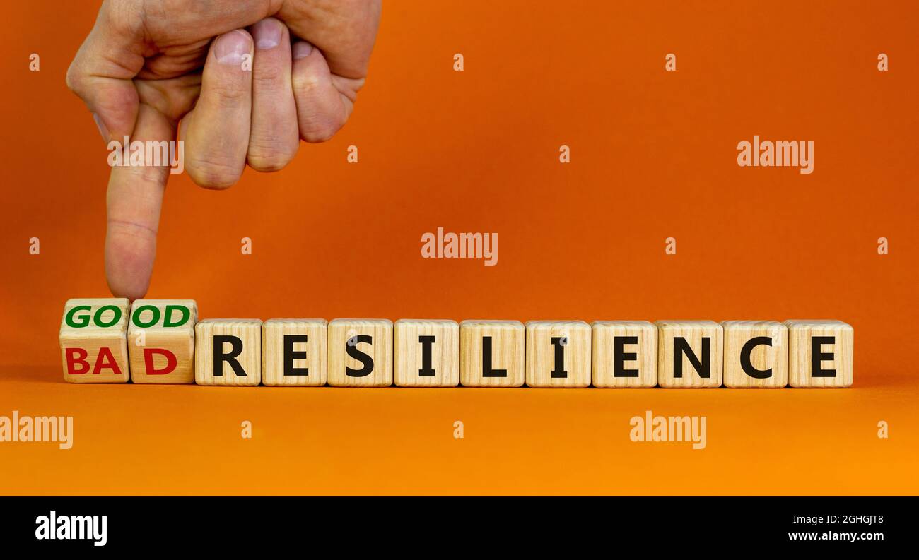Good or bad resilience symbol. Businessman turns wooden cubes, changes ...
