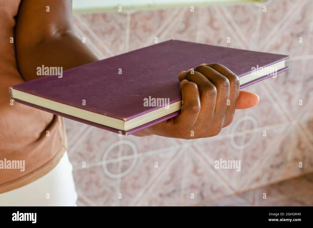 Holding A Closed Bound Book Stock Photo - Alamy