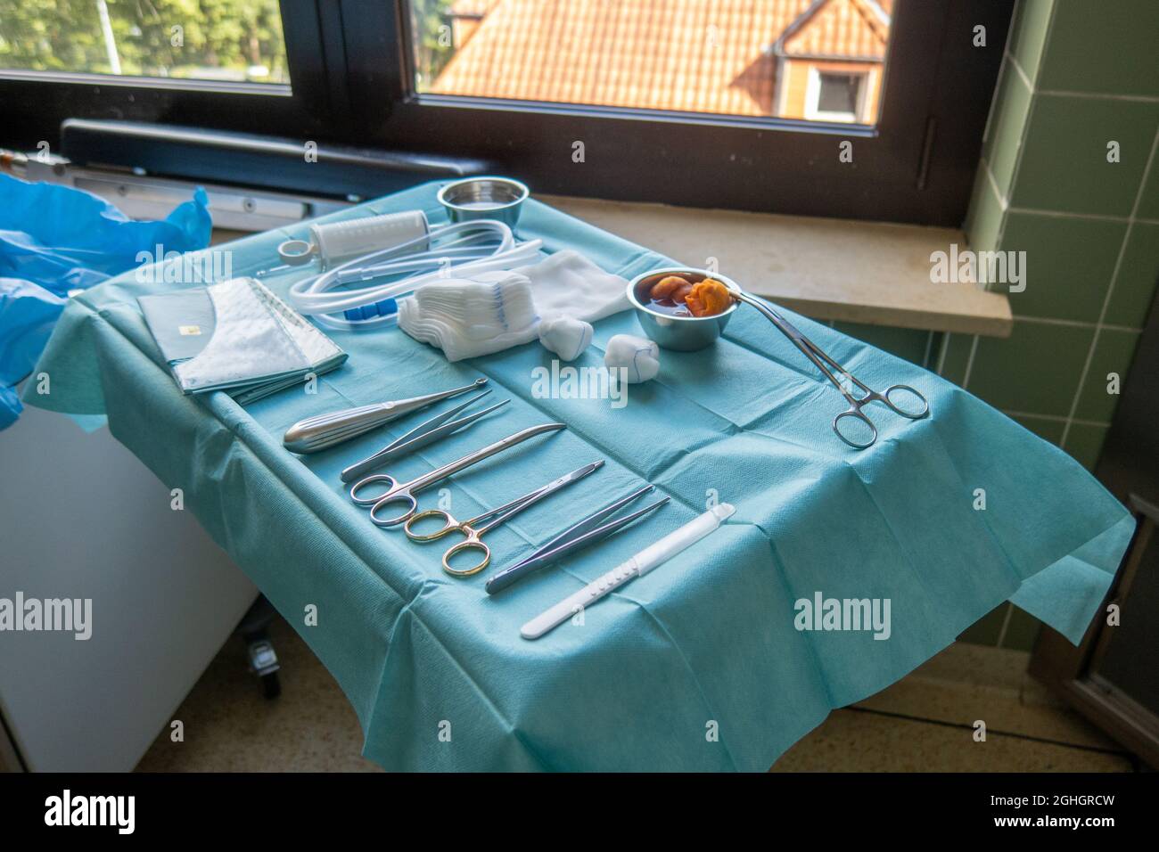 on an instrument table in an operating room lie the instruments for a ...