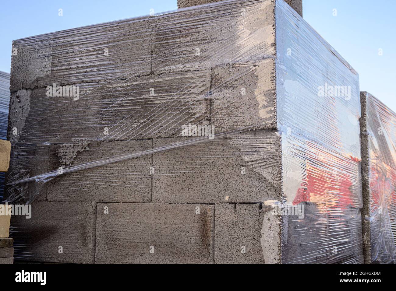 Foam concrete blocks covered with packaging film on wooden pallets in ...