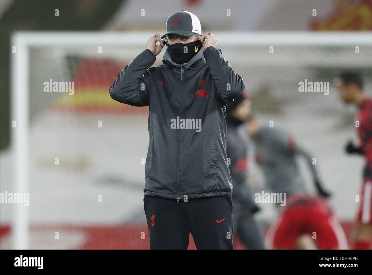 Jurgen Klopp manager of Liverpool adjusts his face mask during the UEFA ...