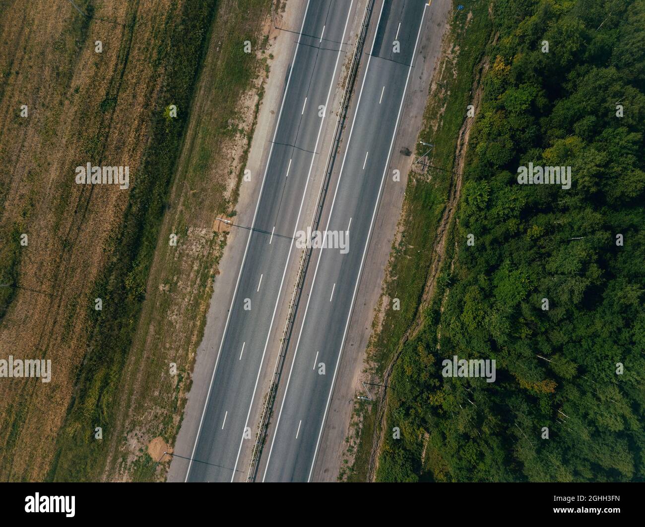 A view from above of an empty paved road in the countryside. Aerial ...