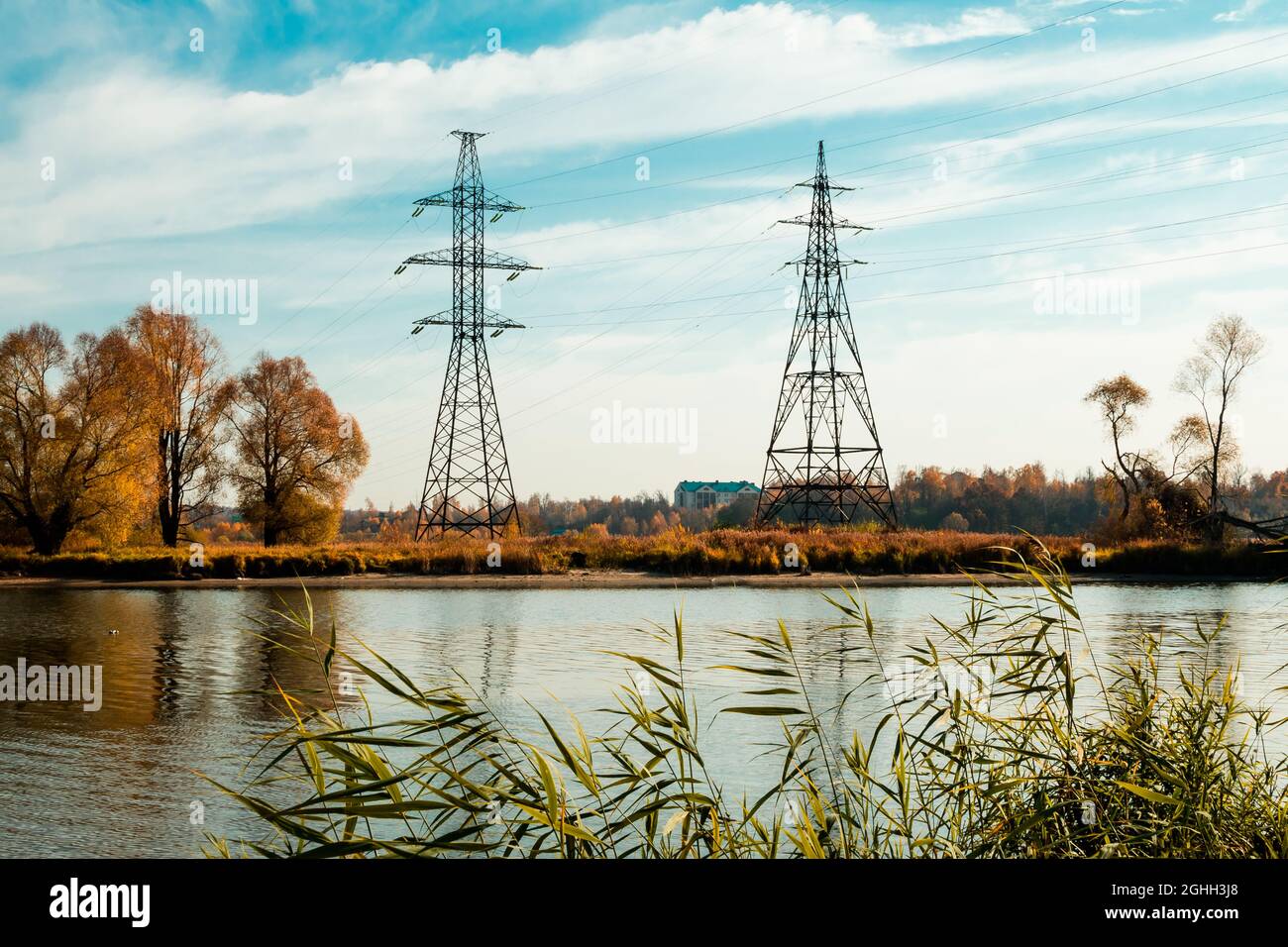 High-voltage power lines crossing the river. High voltage power ...