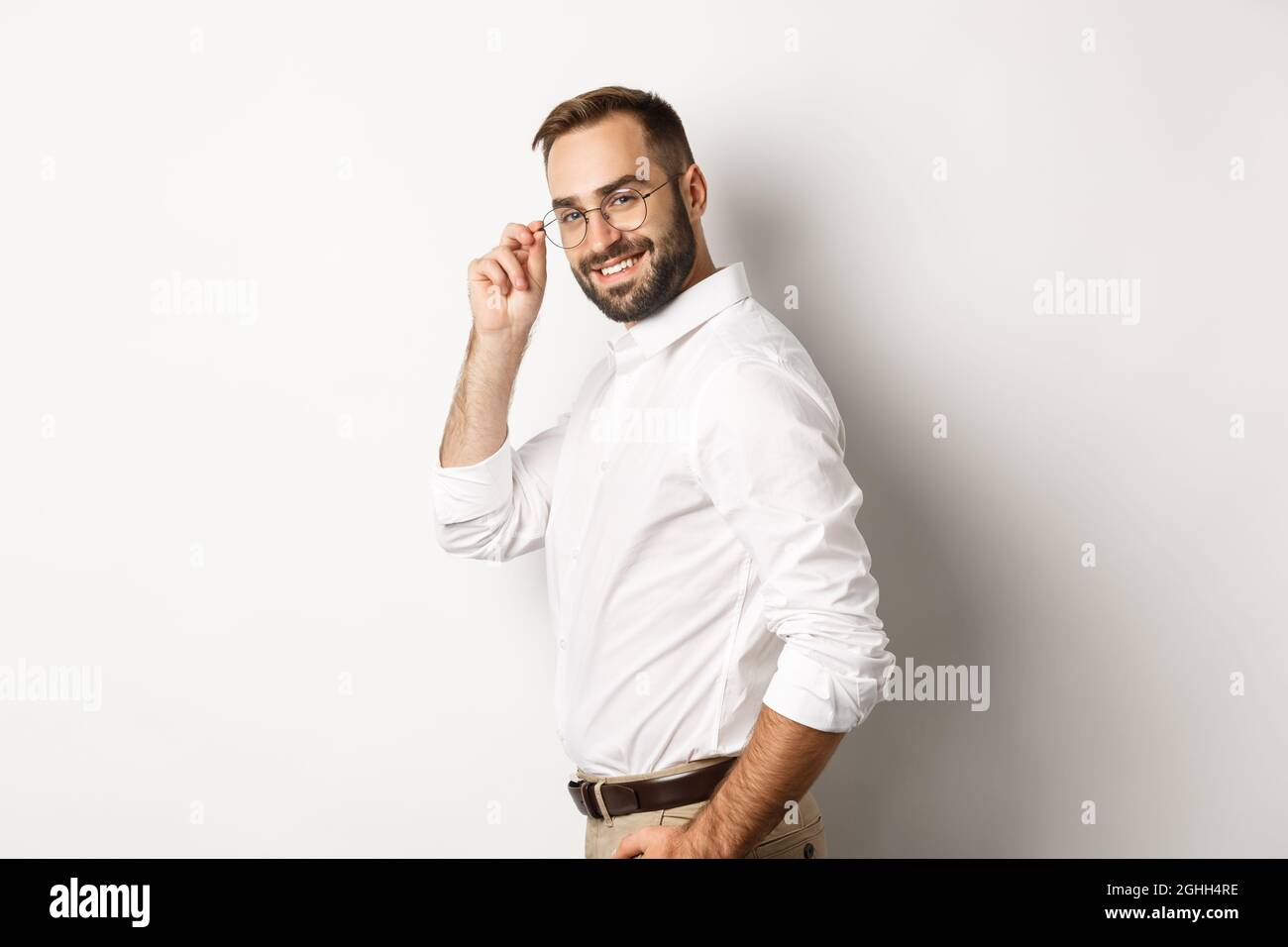 Handsome businessman turn at camera and looking confident, smiling ...
