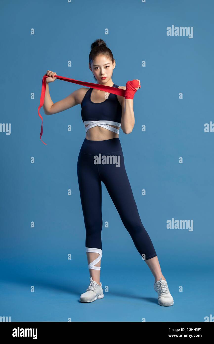 Young woman wrapping hands for boxing Stock Photo - Alamy