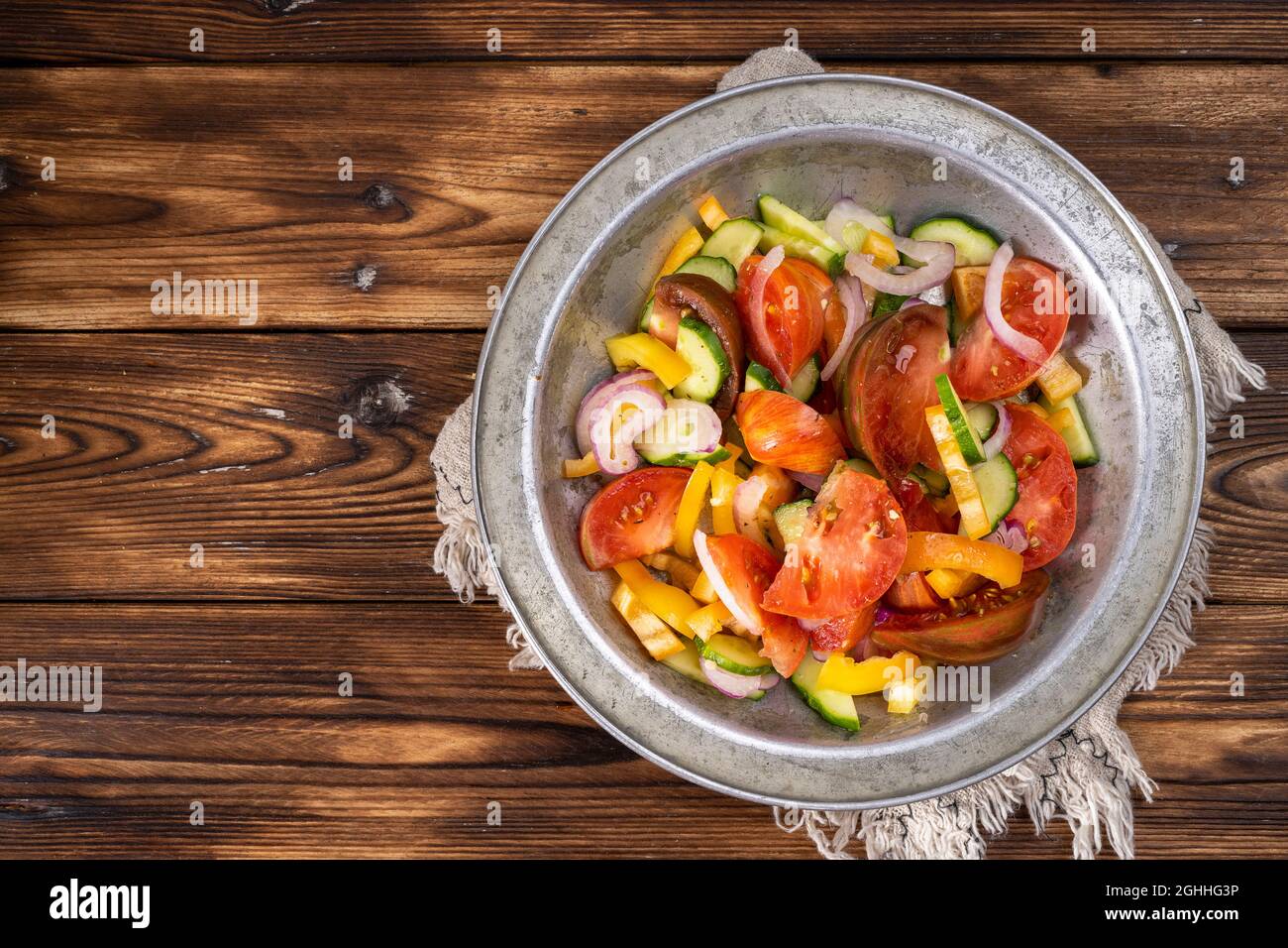 Fresh green salad in metal bowl on wooden table. Rustic style Stock ...