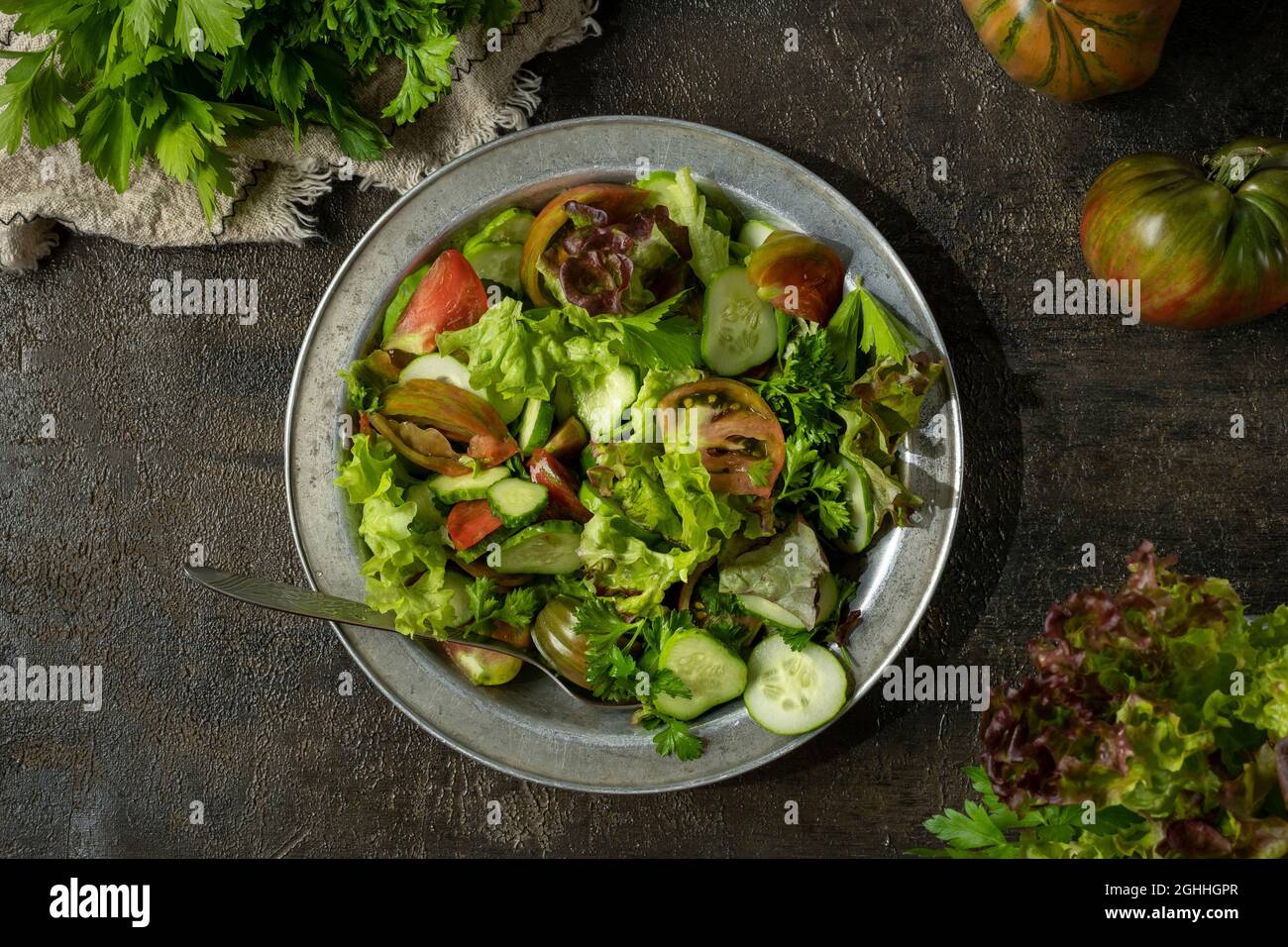 Fresh green salad in metal bowl on wooden table. Rustic style Stock ...