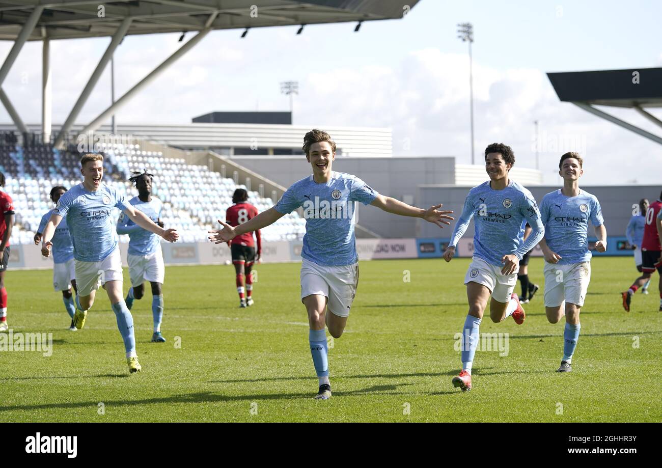 Callum Doyle of Manchester City (C) celebrates after scoring during the ...