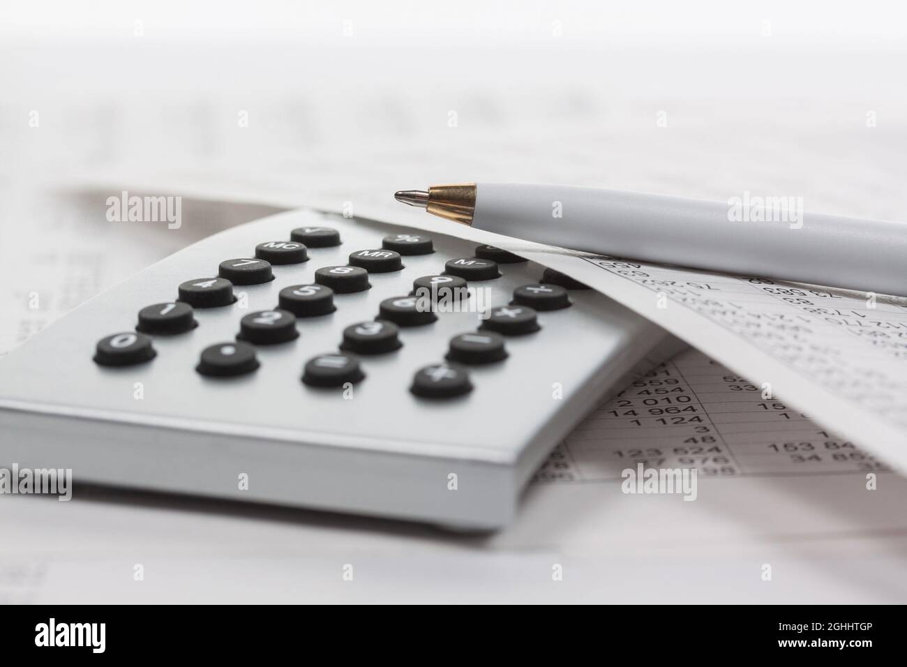Financial accounting Pen and calculator on balance sheets Stock Photo ...