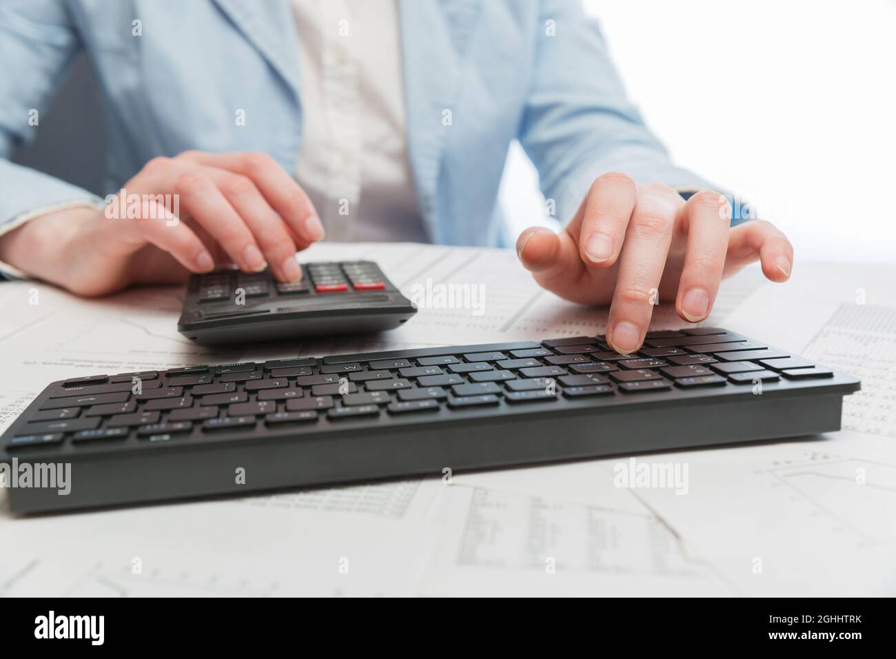 Business woman using calculator and computer keyboard at office Stock ...