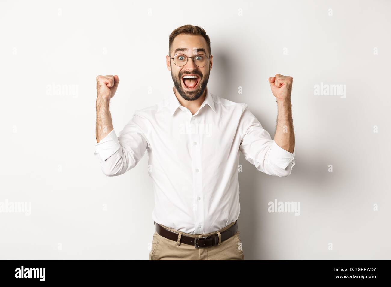 Successful businessman rejoicing, raising hands up and celebrating ...