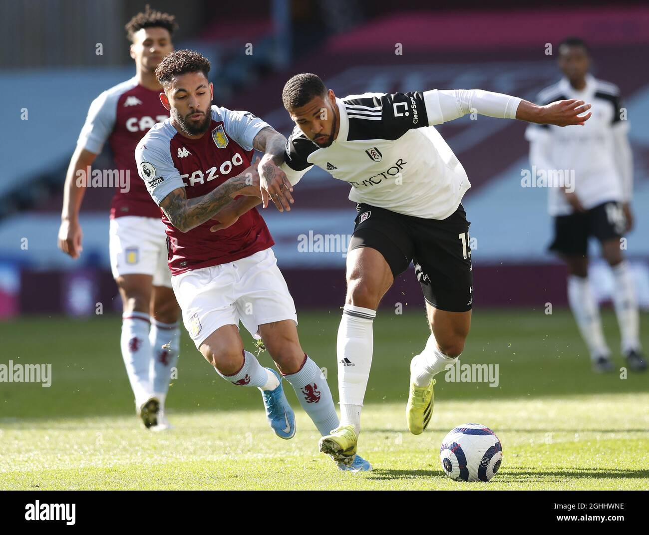 Ruben Loftus-Cheek of Fulham (R) holds off Douglas Luiz of Aston Villa ...