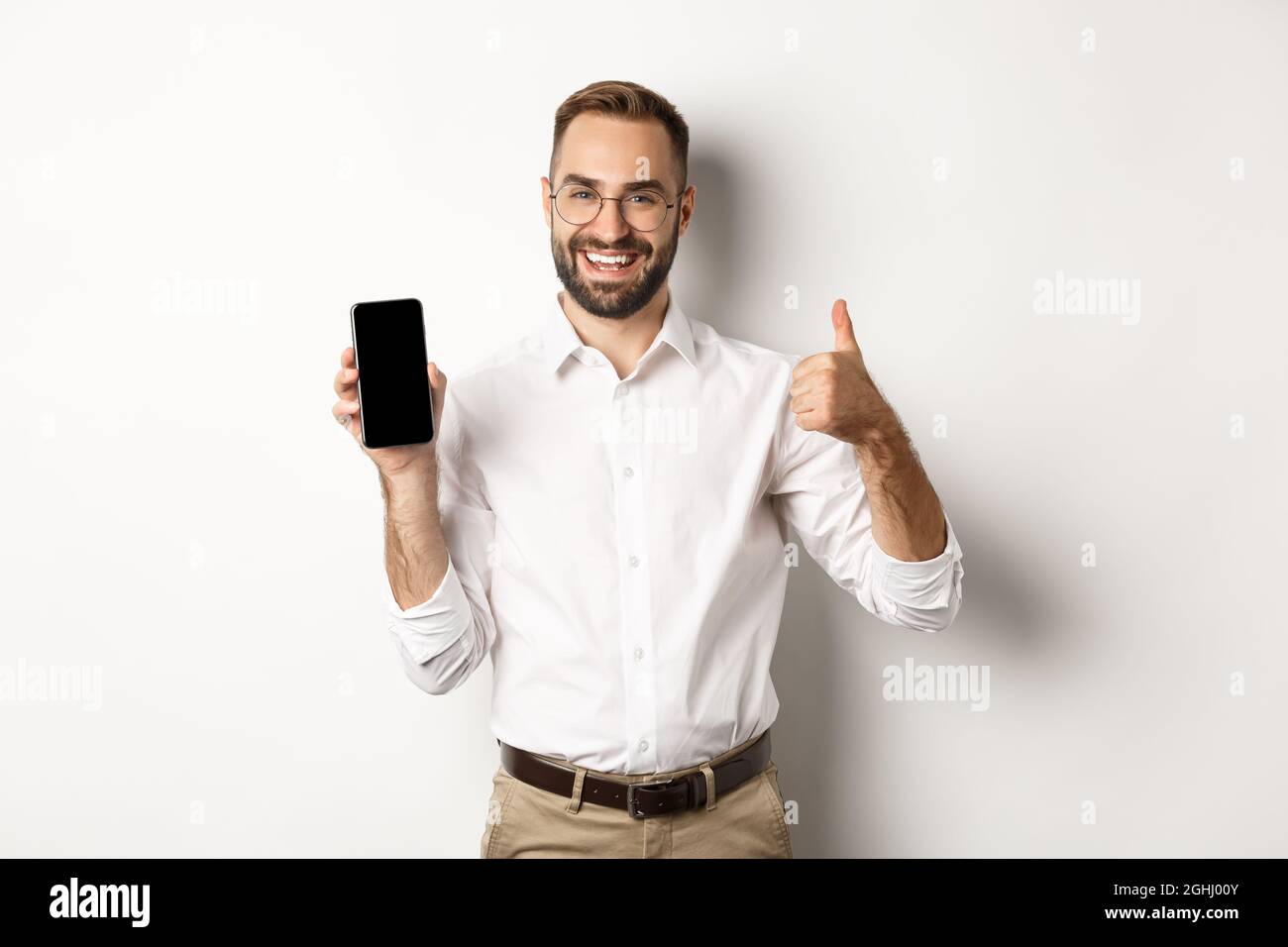 Satisfied business man in glasses showing thumbs up and demonstrating ...