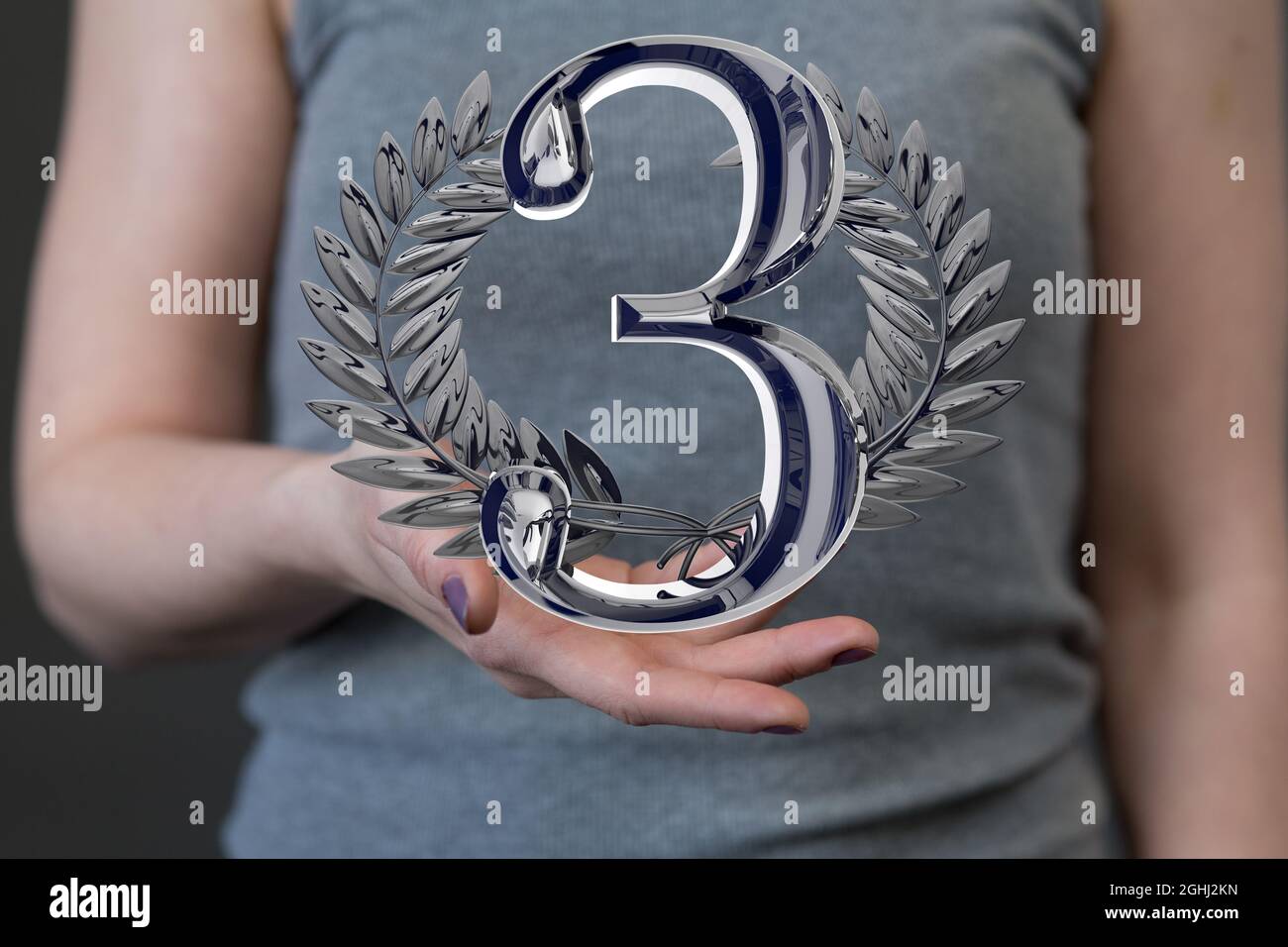 3d silver rendering of 3 with laurel wreath hovering over female's palm ...
