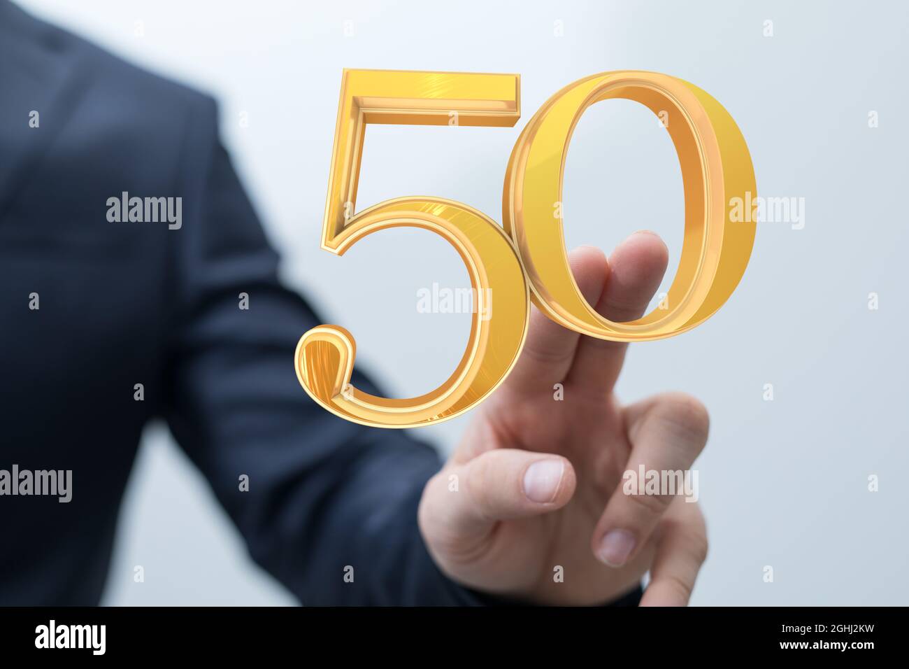 Closeup of a man touching a 3d golden rendering of 50 Stock Photo - Alamy