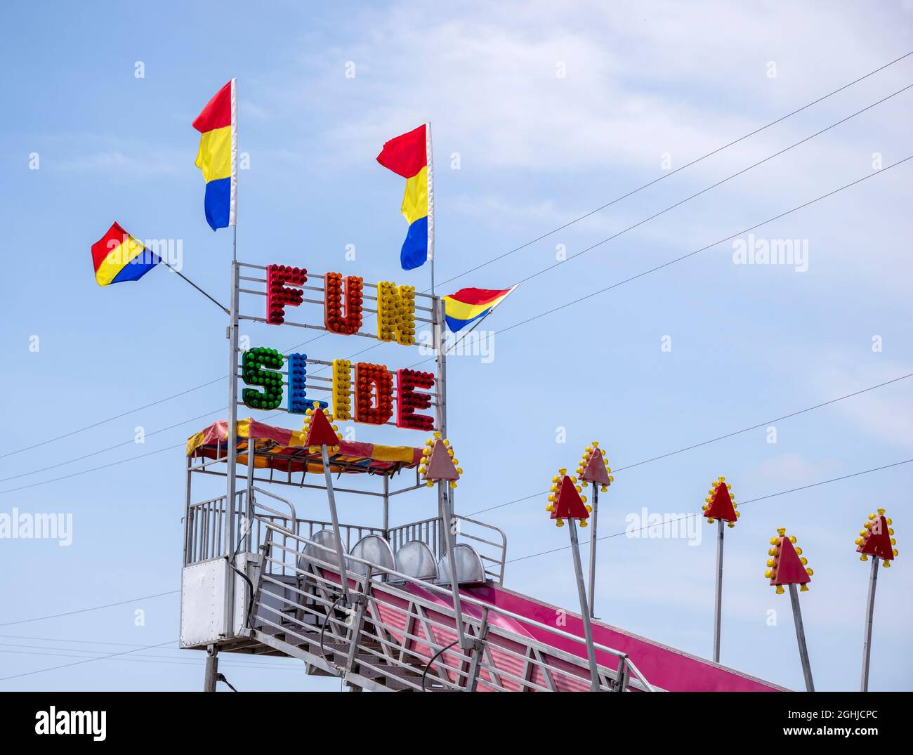 Fun Slide carnival ride, detail of top, colorful flags and lights Stock ...