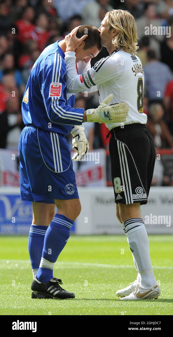 Robbie Savage of Derby County kisses the head of Stephen Bywater of ...