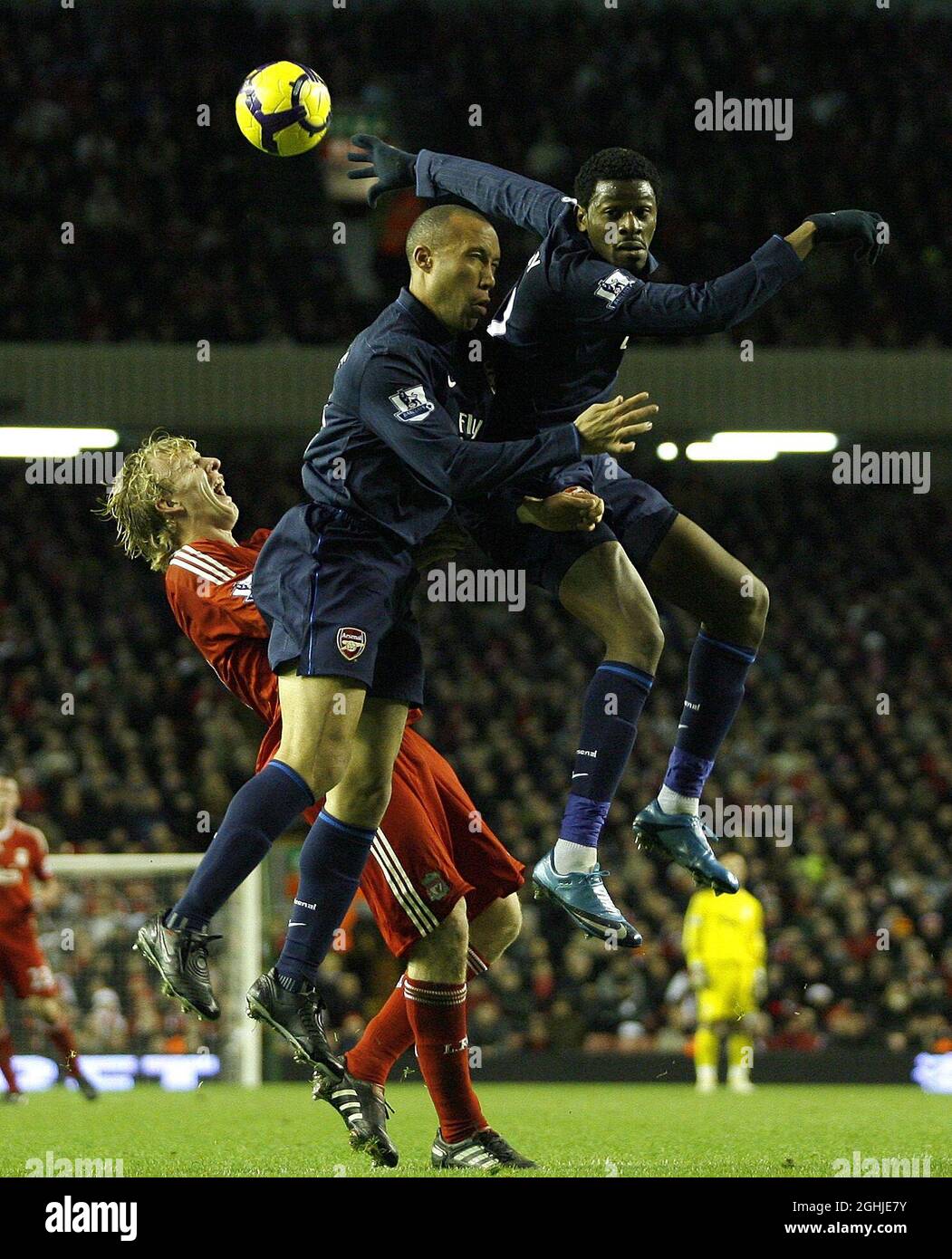 Liverpools dirk kuyt jumps tackle hi-res stock photography and images ...