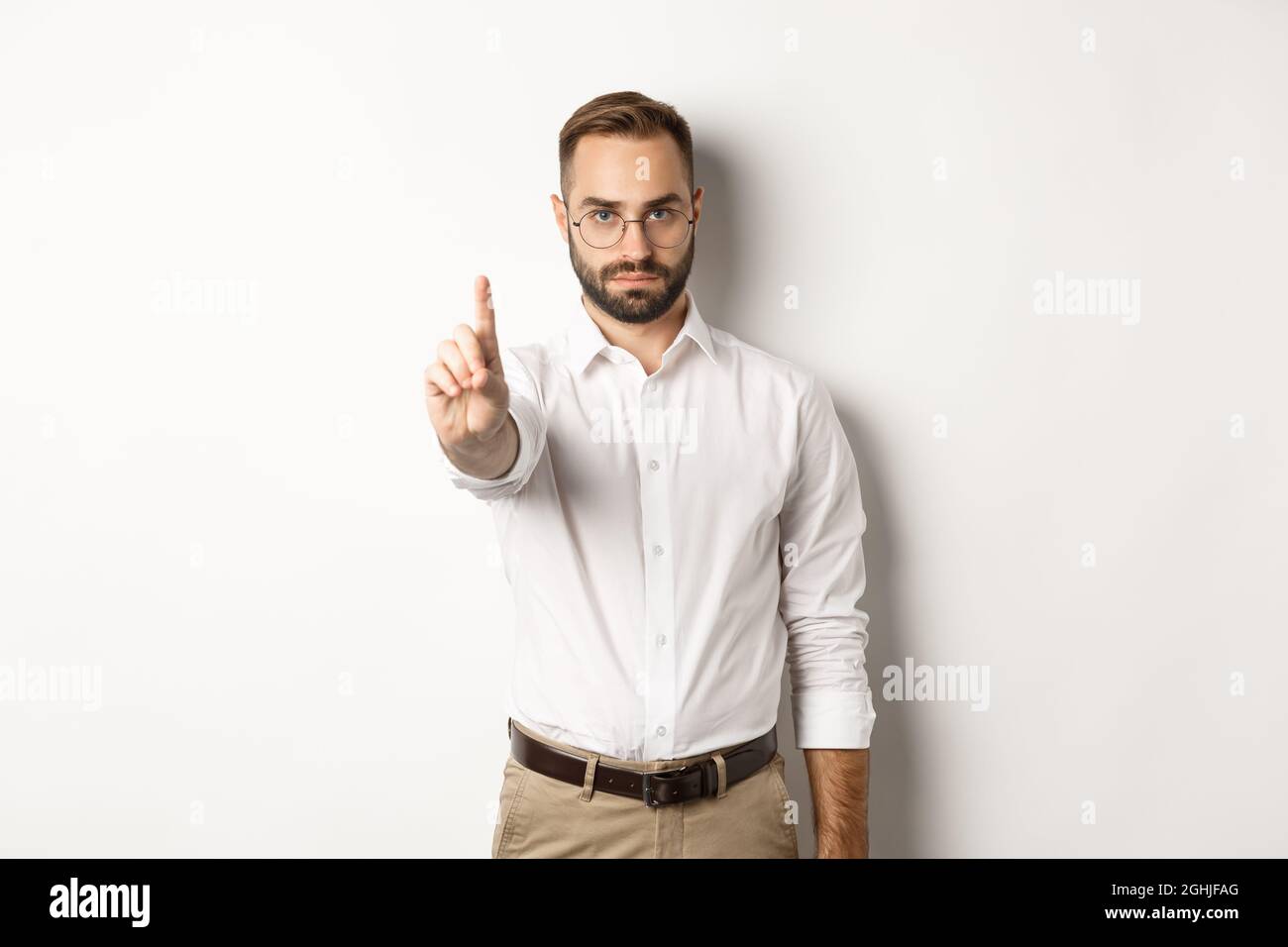 Serious man in glasses showing stop sign, shaking finger to prohibit ...