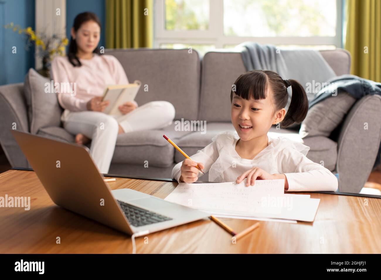 Cute girl taking online courses at home Stock Photo - Alamy