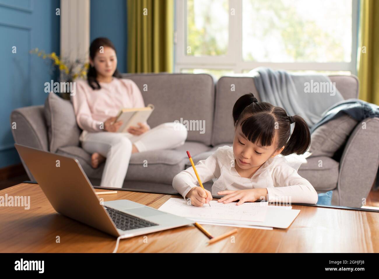 Cute girl taking online courses at home Stock Photo - Alamy