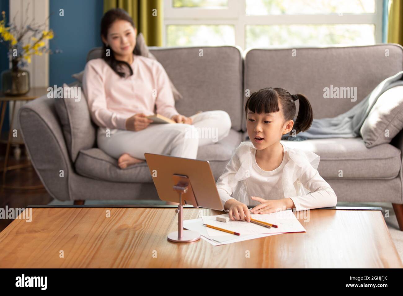 Cute girl taking online courses at home Stock Photo - Alamy