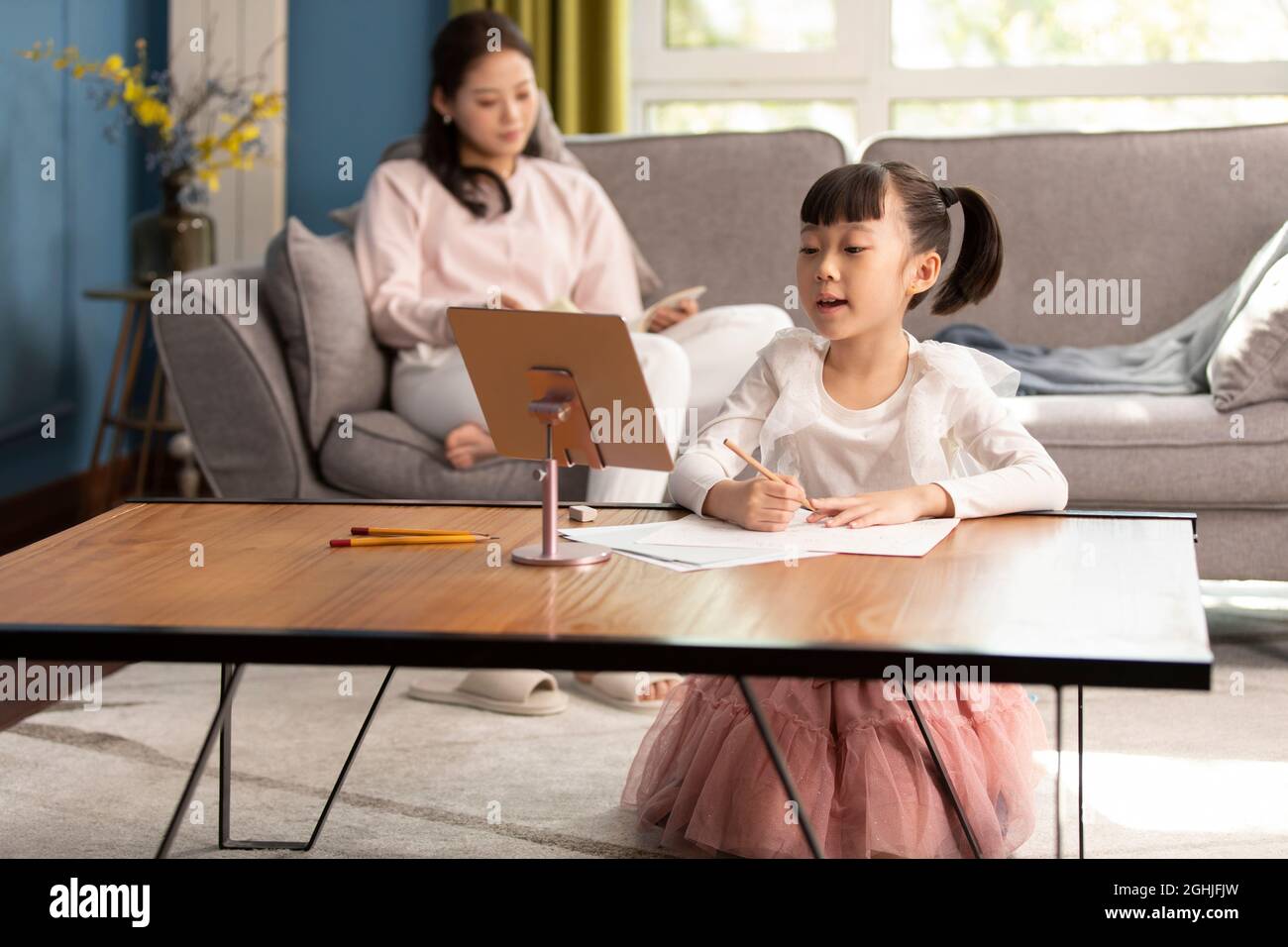 Cute girl taking online courses at home Stock Photo - Alamy