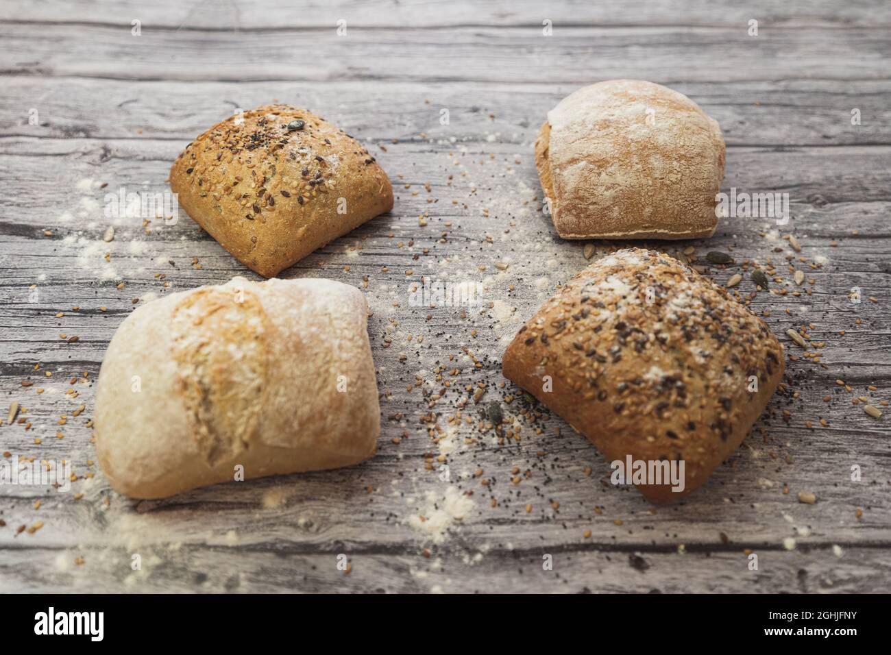 Assorted breads on a gray wooden table Stock Photo - Alamy