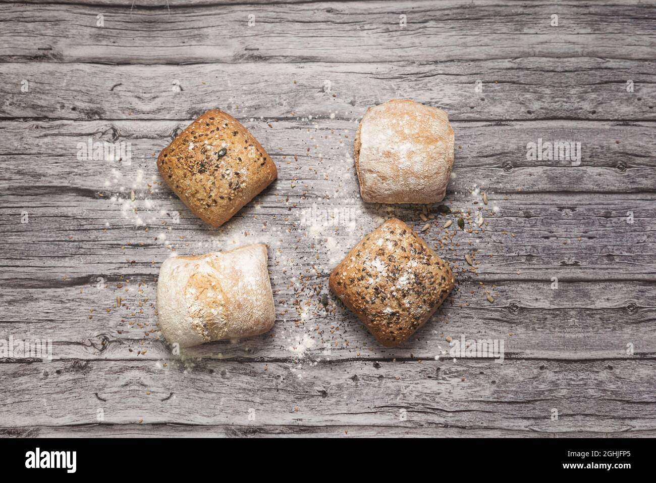 Assorted breads on a gray wooden table Stock Photo - Alamy