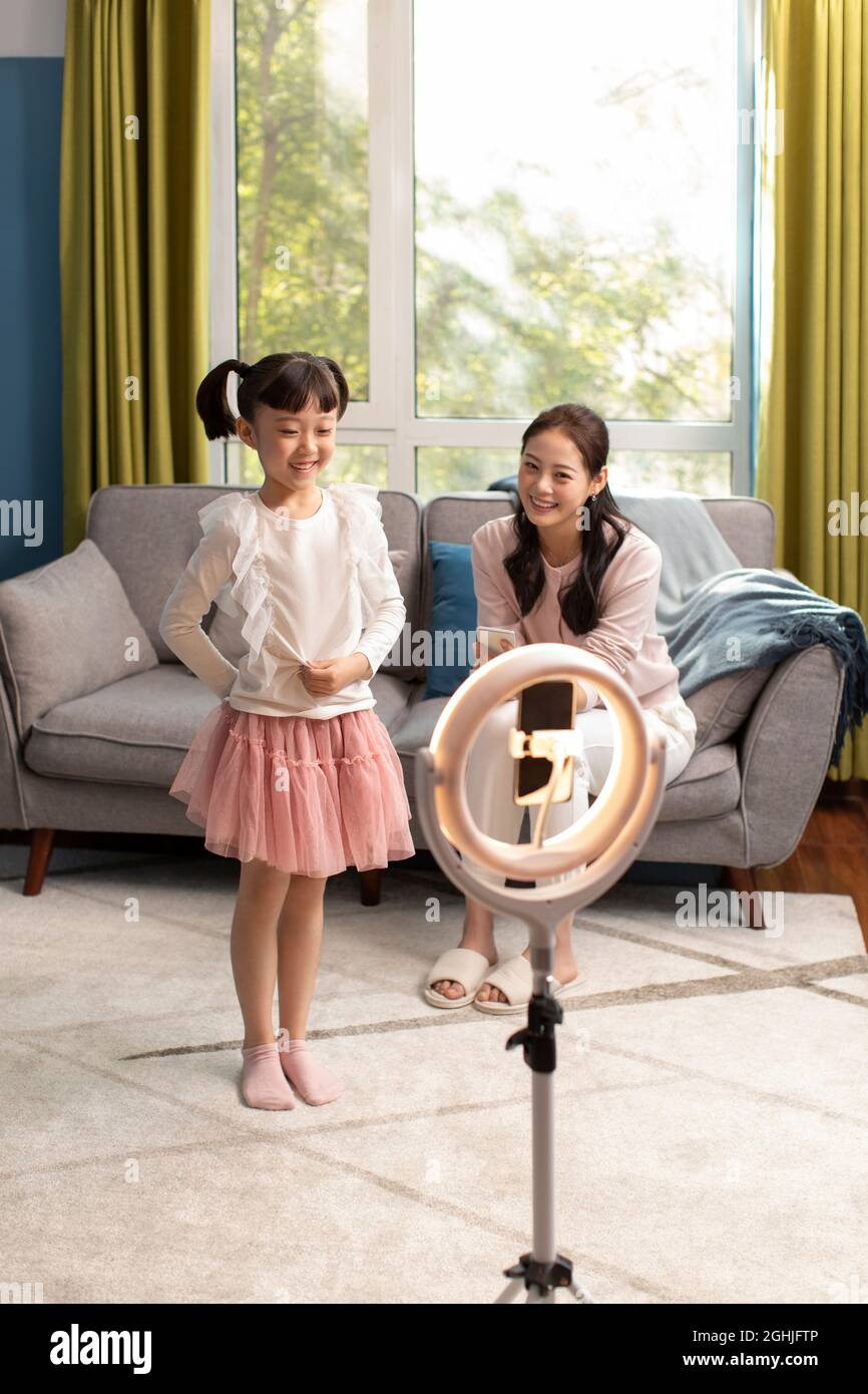 Little girl doing live webcast at home Stock Photo - Alamy