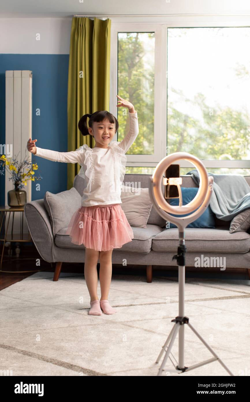 Little girl doing live webcast at home Stock Photo - Alamy